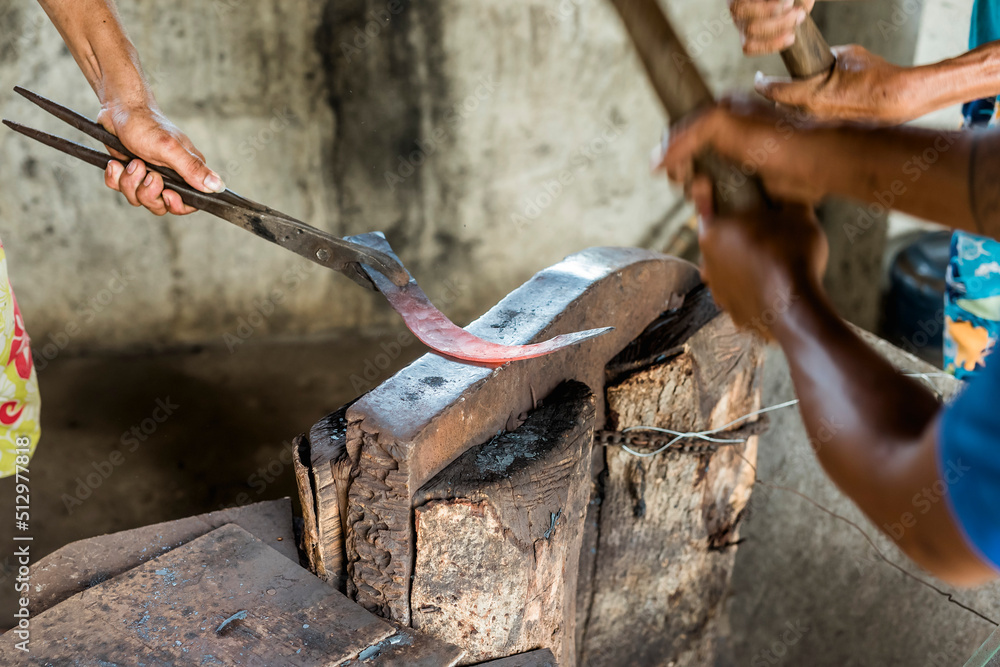 Loay, Bohol, Philippines - Local blacksmiths forge and shape a bolo or ...