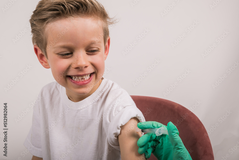 happy Boy getting flu shot. Cropped nurse giving child intramuscular ...