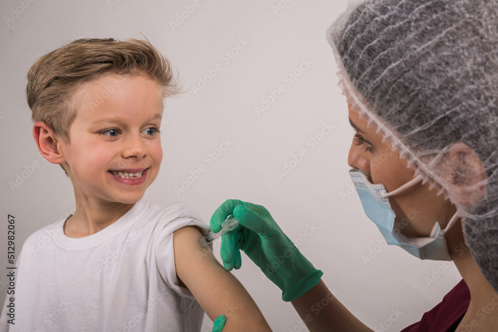 Boy getting flu shot. Cropped nurse giving child intramuscular ...