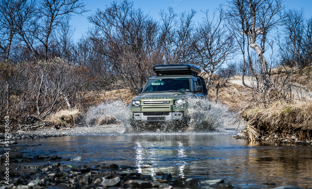 Rybachy, RUSSIA - May 30 2022: Off-roading New Land Rover Defender. The ...