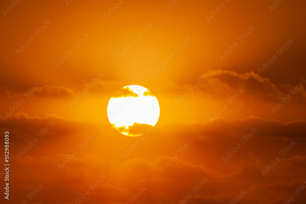 Sun with orange clouds in sunset sky Stock Photo | Adobe Stock
