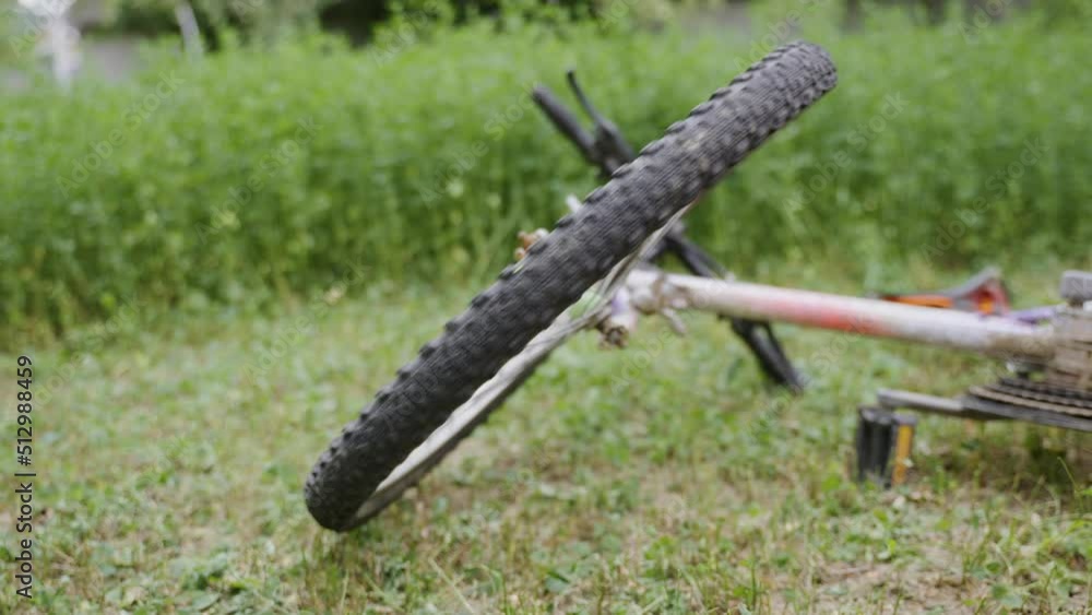 The curved wheel of the bicycle rotates around its axis and stops ...