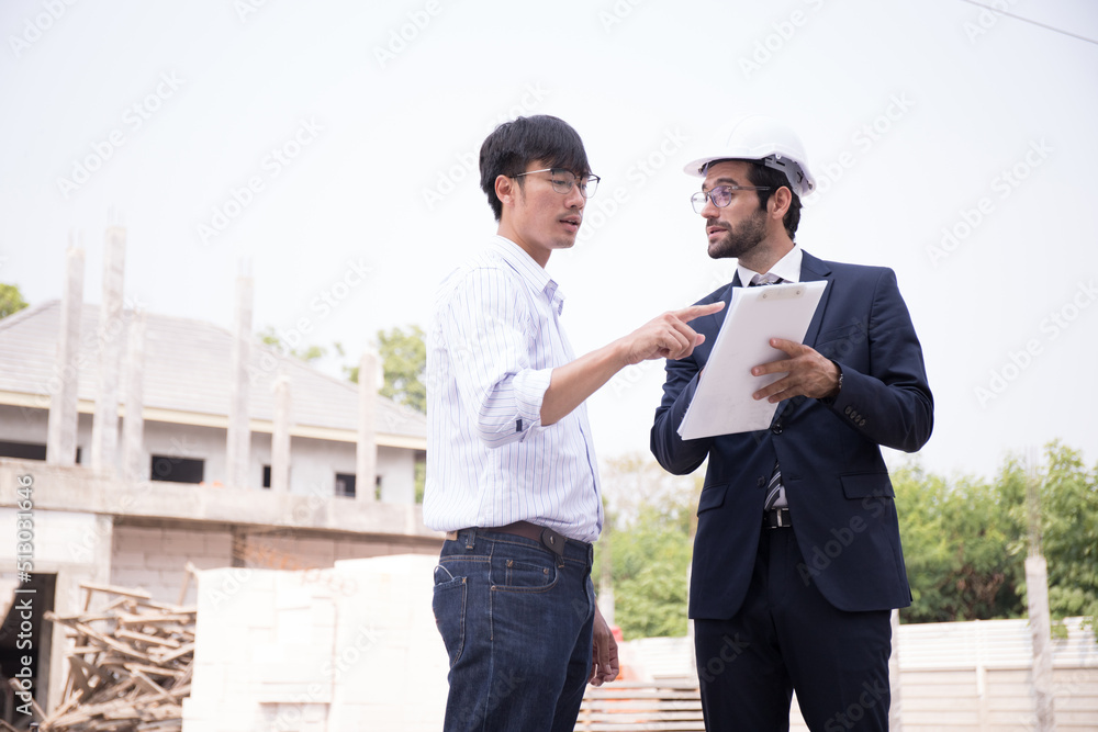 Architect and construction manager formal suit work and white helmets ...