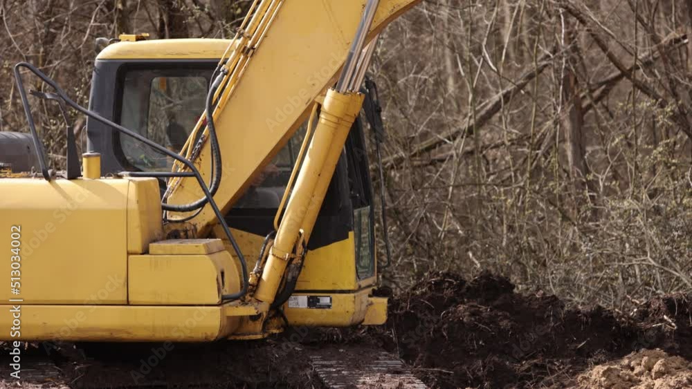 Working with backhoe by digging ground at construction site. Excavator ...