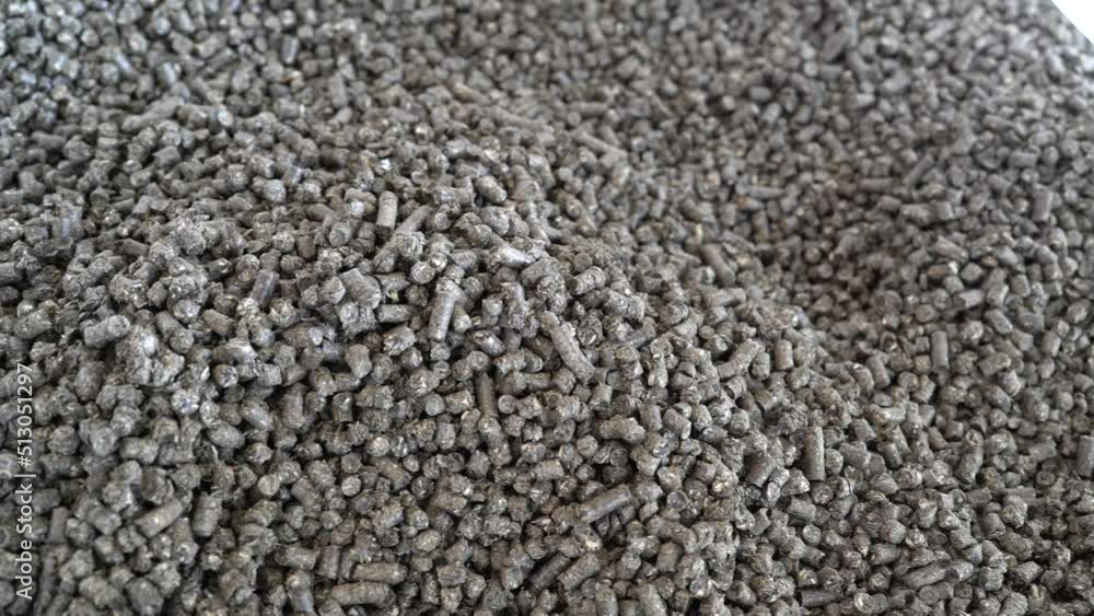 Pile of pressed pellets from waste sunflower oil production. Seed husk ...