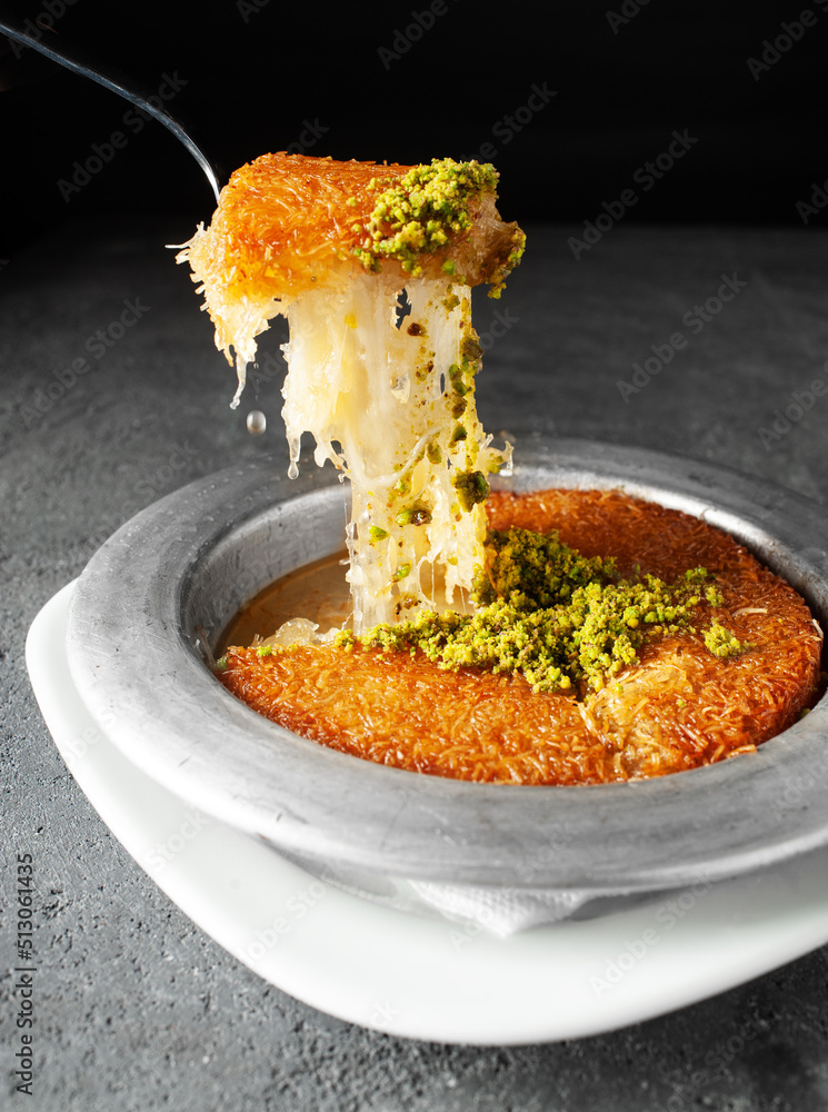 Turkish dessert kunefe, kunafa, kadayif with pistachio powder and ...