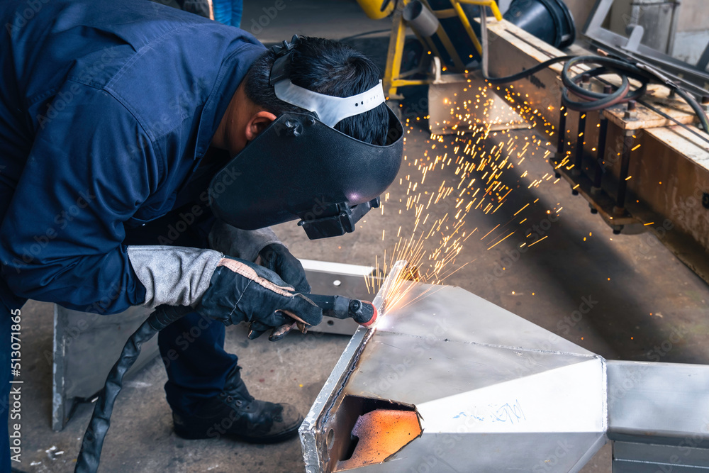 Welder is welding the steel in the factory. Weld the steel in dark ...
