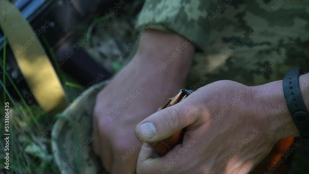 Soldier man loading rifle magazine. Close up of soldier loading ...