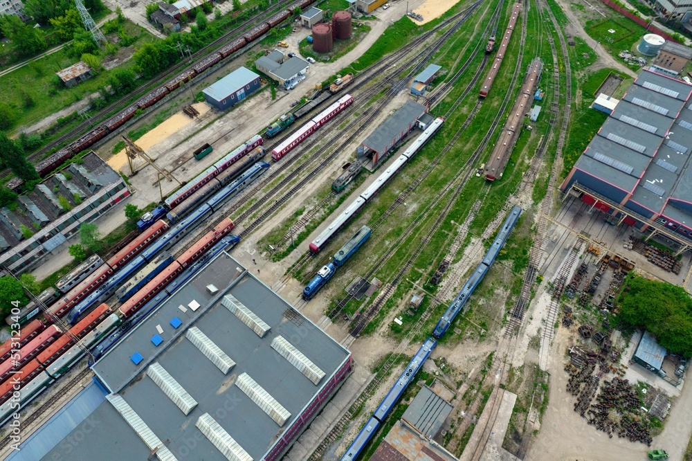 Aerial view above an industrial railroad yard with rows of freight ...