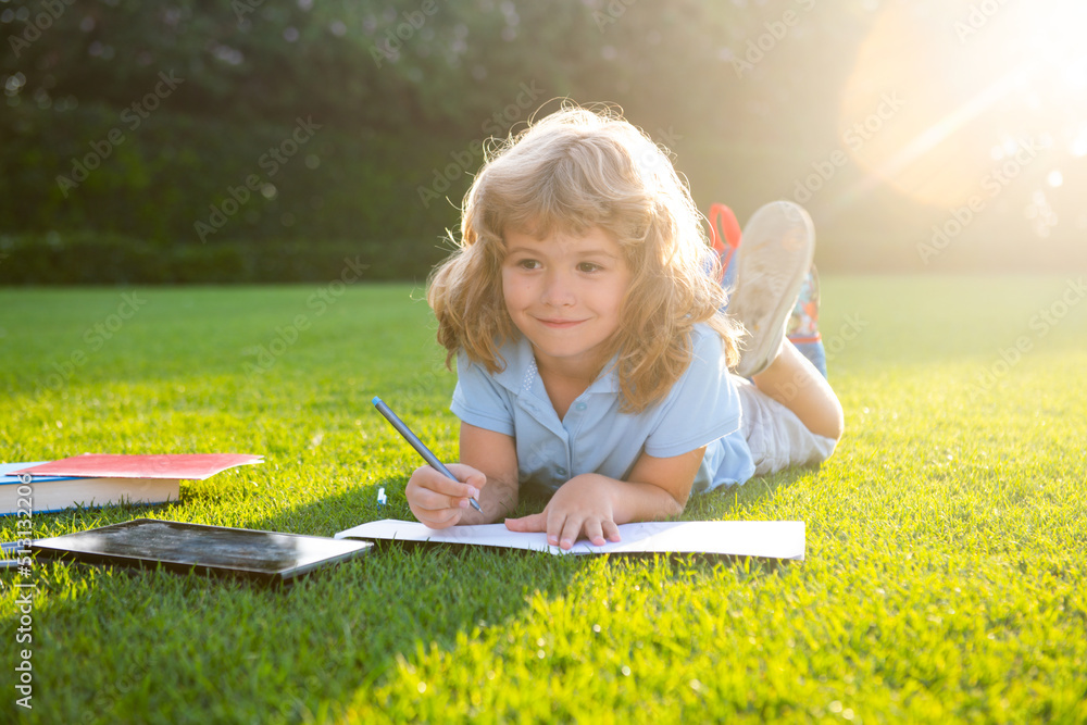 Cute childr boy writing notes in copybook outdoors. Summer camp. Kids ...