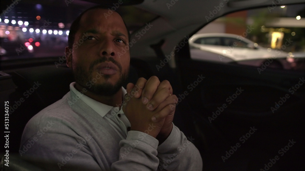 Anxious person in car backseat commuting at night after work inside ...