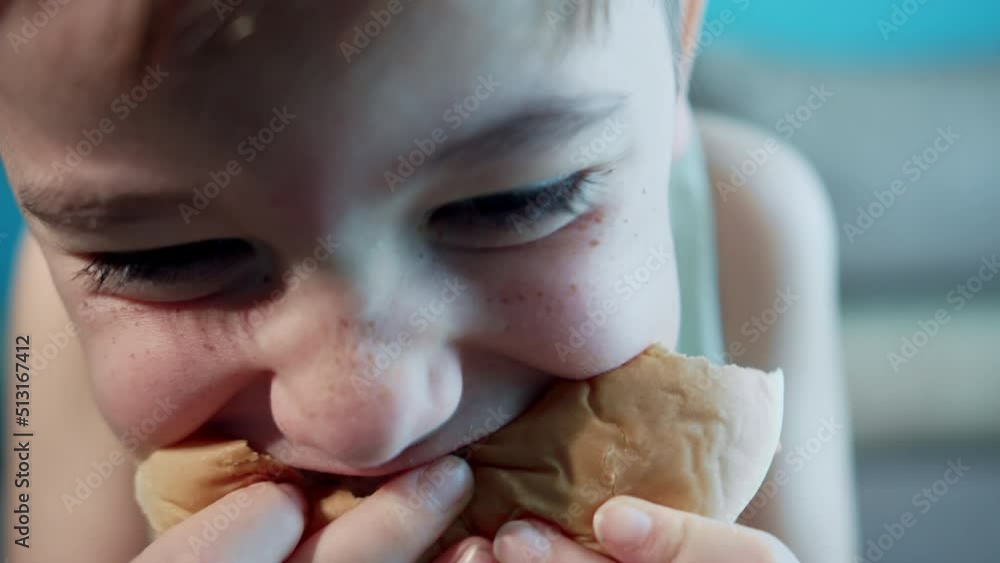 Close-up mouth of a hungry man with braces on his teeth greedily bites ...