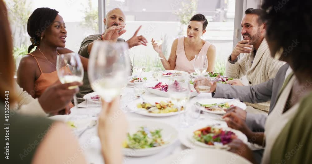 Diverse group laughing at a party enjoying their food and wine. People ...