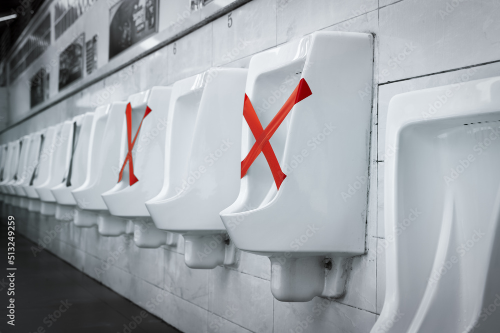 White ceramic urinals in men public toilet. Social distancing in men ...