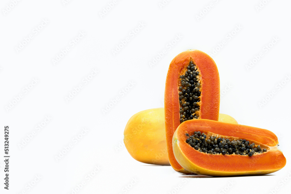 Whole and half of ripe papaya fruit with seeds isolated on white ...