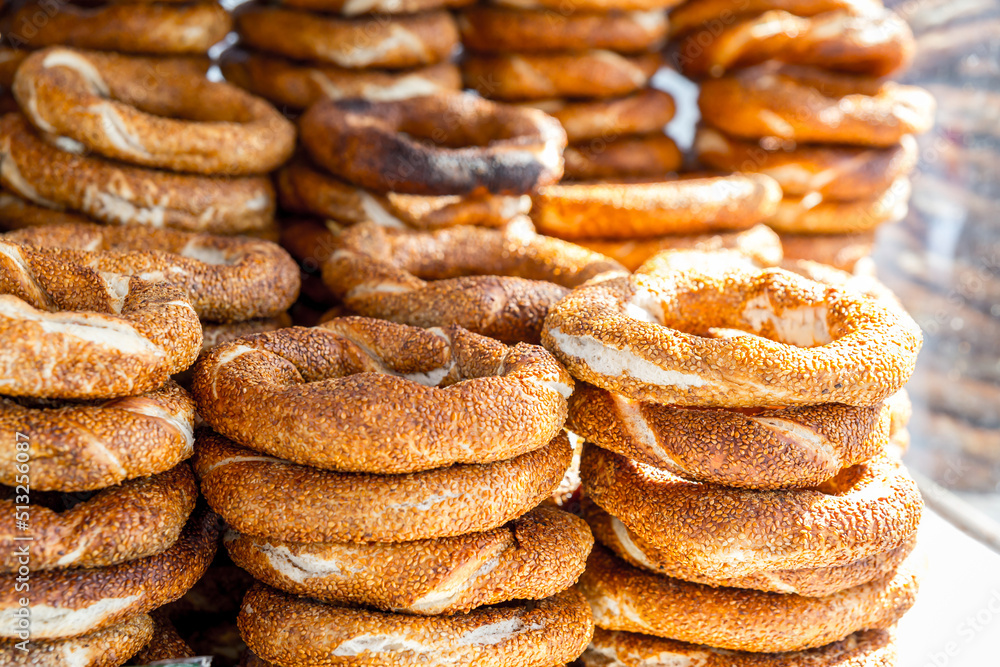 Stack of simit (circular bread) at sunny day. Simit is a popular street ...