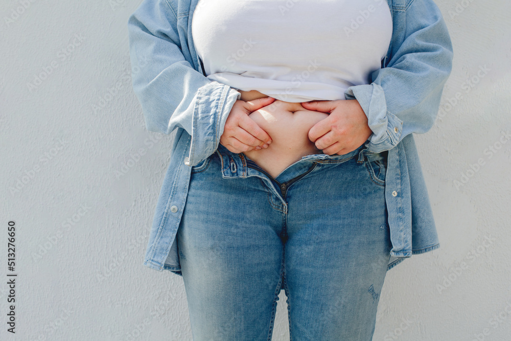 Young woman with flabby belly and thick sides showing fat belly in ...