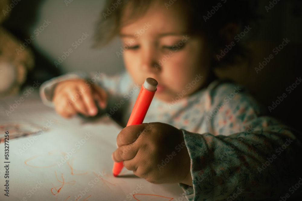 child drawing in room. Pencil and hand in focus Stock Photo | Adobe Stock