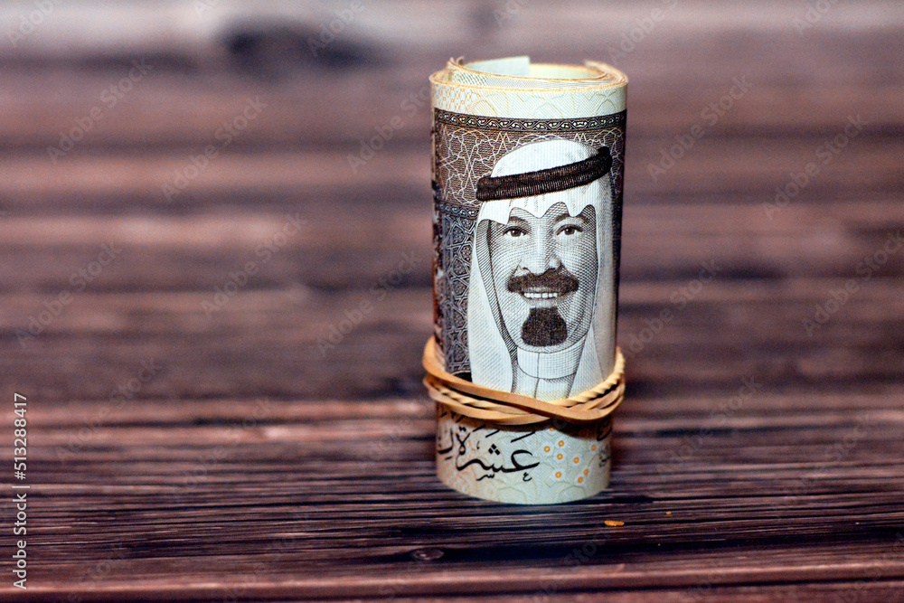 10 SAR ten Saudi riyals cash money banknote bills rolled up with rubber ...