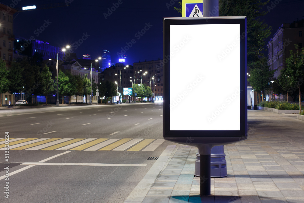 Vertical billboard advertising in the night city. Sky glows from the ...