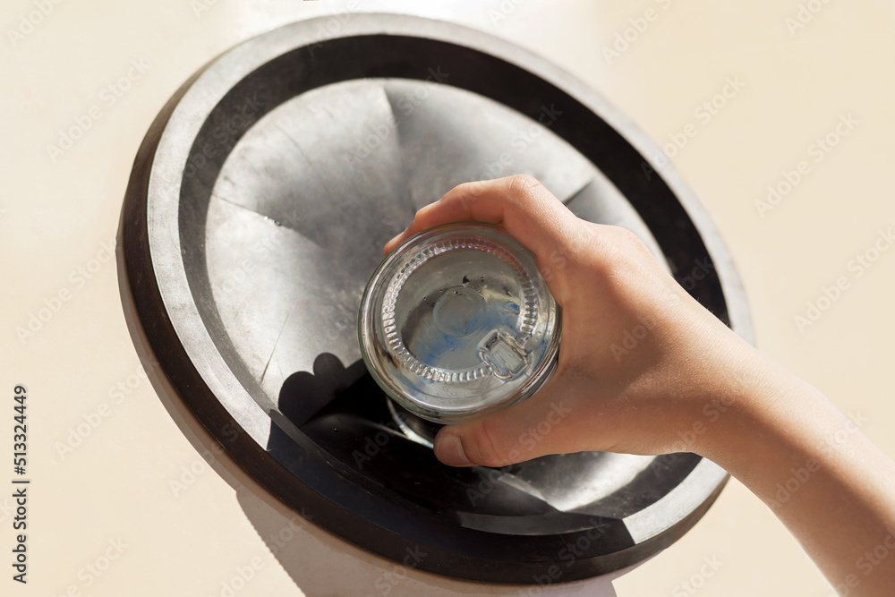 Sorting Waste. Glass Bottle throwing in Glass Recycling Container ...