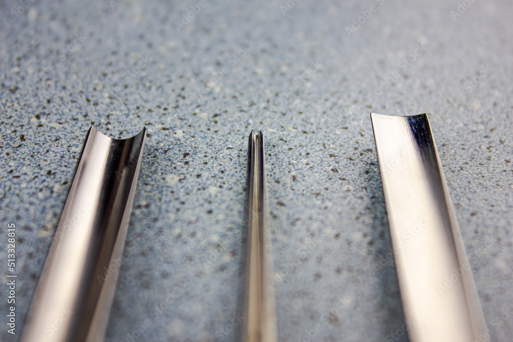 Forged blades of steel incisors close-up.Sharp metal sharpened blades ...