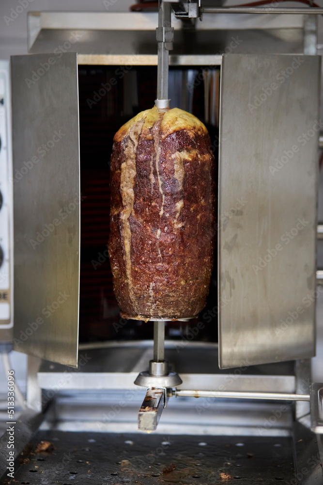 shawarma on a spit. Doner kebab on a rotating vertical spit ...