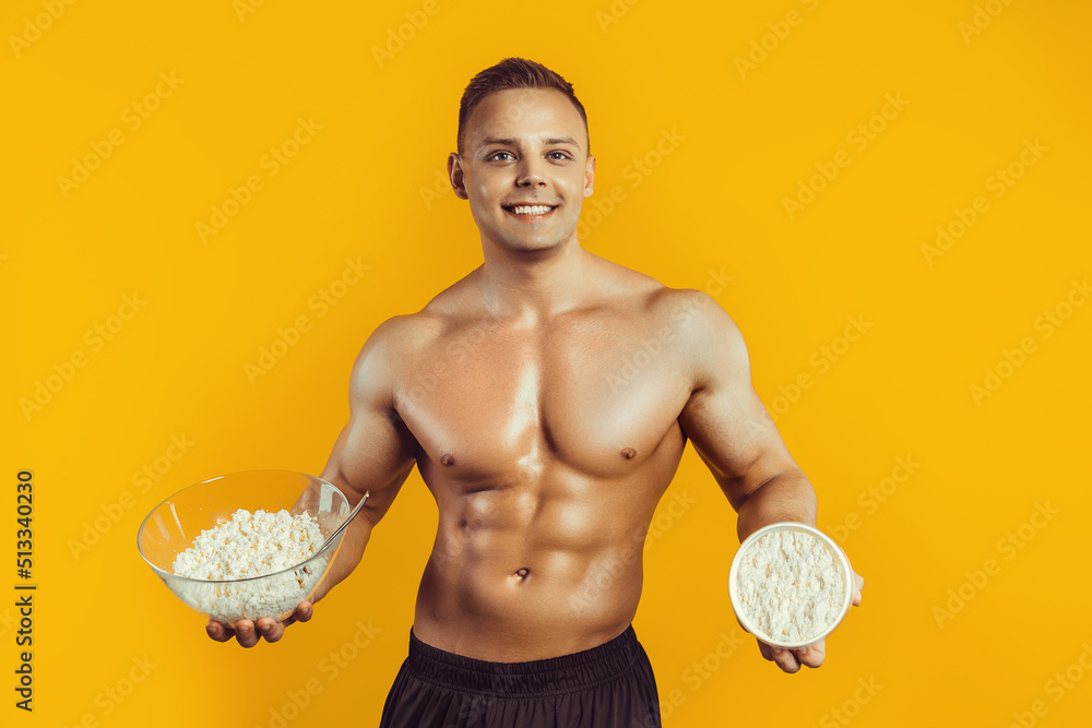 Strong, healthy man posing on a black background. Bodybuilder, athlete ...