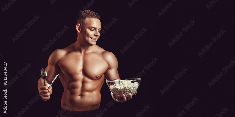 Strong, healthy man posing on a black background. Bodybuilder, athlete ...