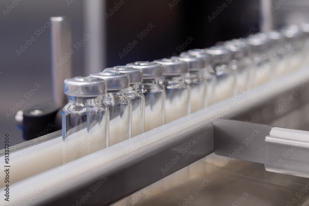 Conveyor belt with empty medical injection glass vials - pharmaceutical ...
