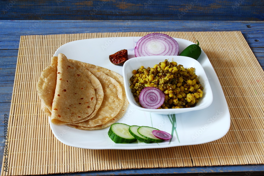 indian gujarati traditional food dish or thali of chapati,roti or ...