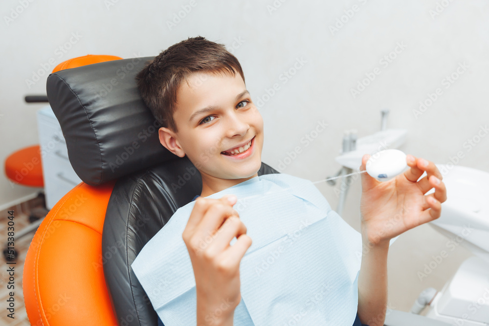 portrait of a 12 year old smiling boy brushing his teeth with dental ...