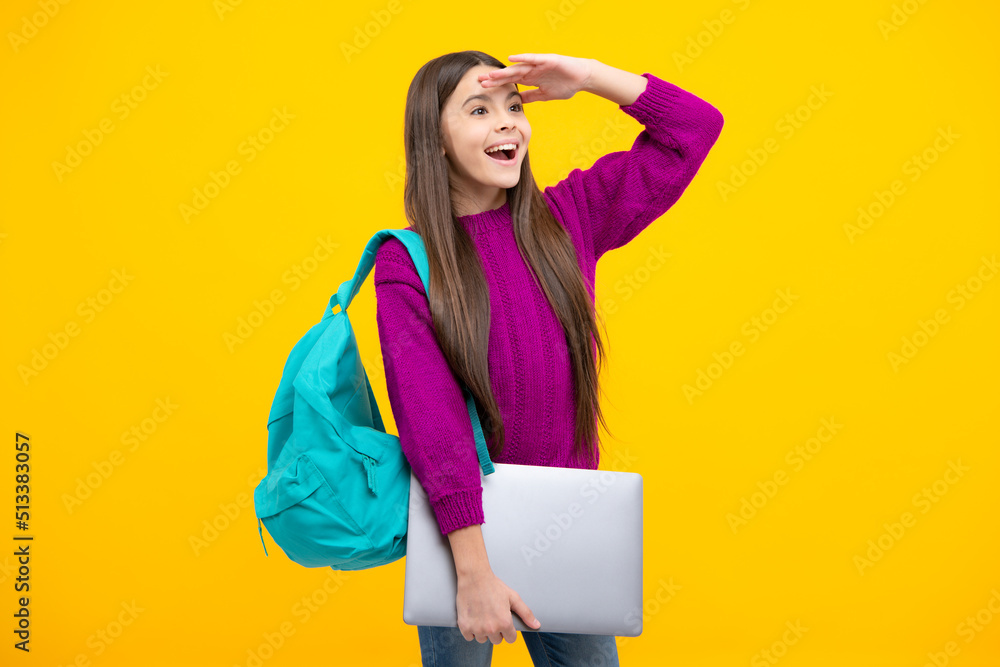 Excited face. Teen schoolgirl hold laptop on isolated studio background ...