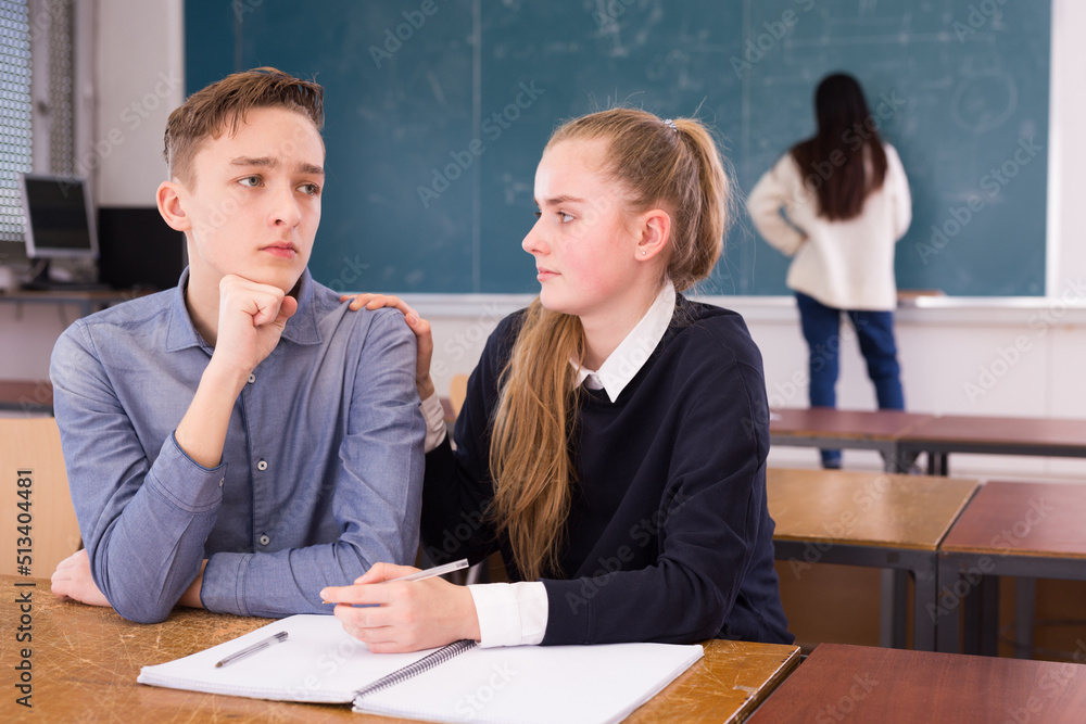 Teen girl student supporting her friend upset because of failed exam in ...