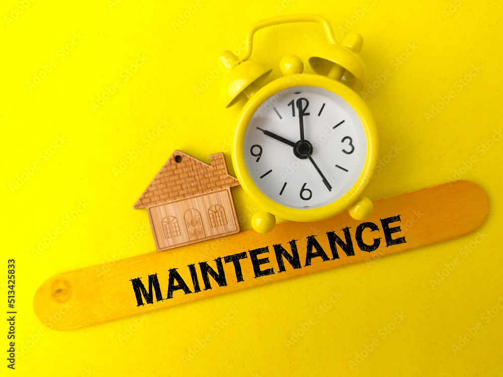 Clock and wooden house with the word MAINTENANCE on yellow background ...