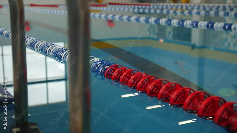 Plastic separator chain on swimming pool with fresh clear water in ...