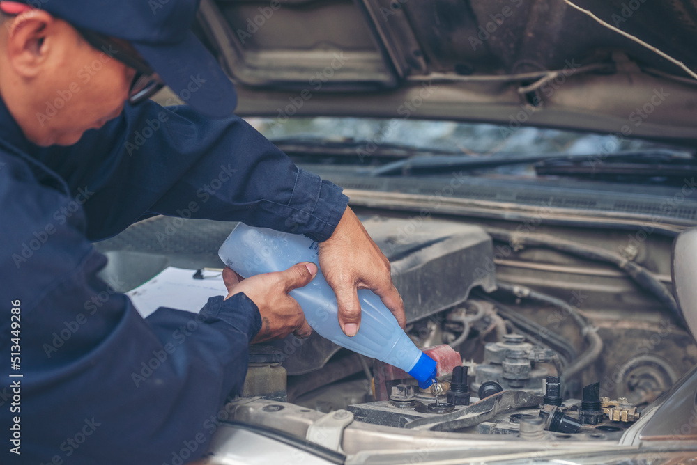 Car Mechanic man hands pouring Deionized purified Distilled water for ...
