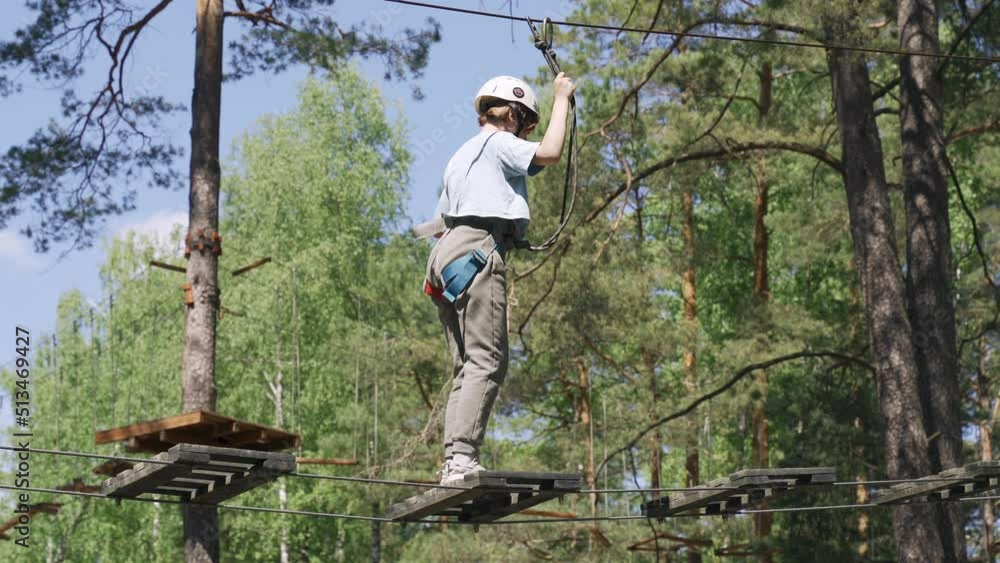 Brave teenage girl overcomes difficult obstacles while walking along a ...