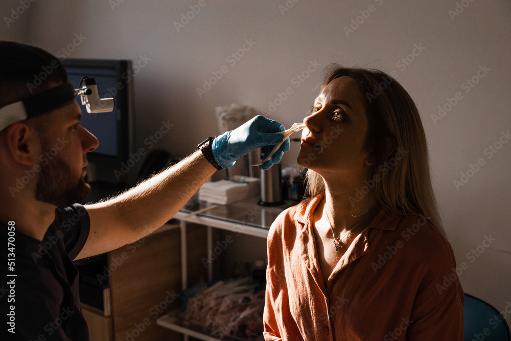Rhinoscopy of woman nose. Consultation with doctor. Otolaryngologist ...