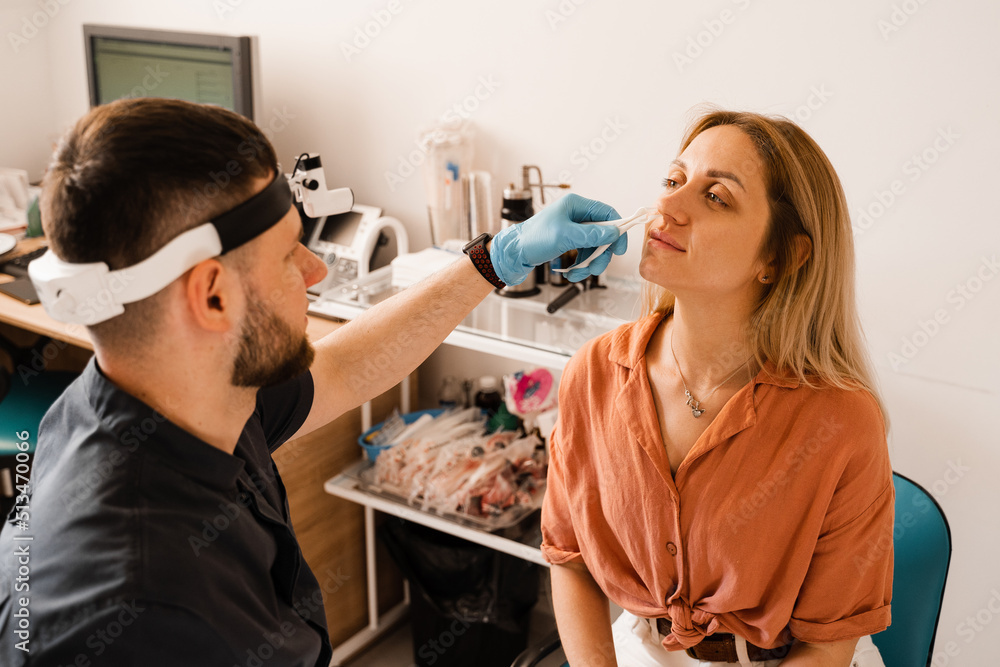 Rhinoscopy of woman nose. Consultation with doctor. Otolaryngologist ...