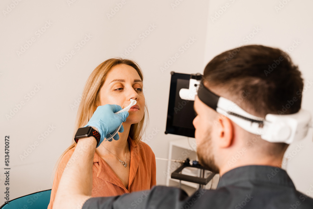 Rhinoscopy of woman nose. Consultation with doctor. Otolaryngologist ...
