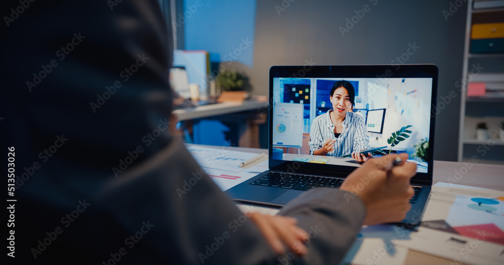 Asia woman using laptop talk to colleagues about work in video call ...