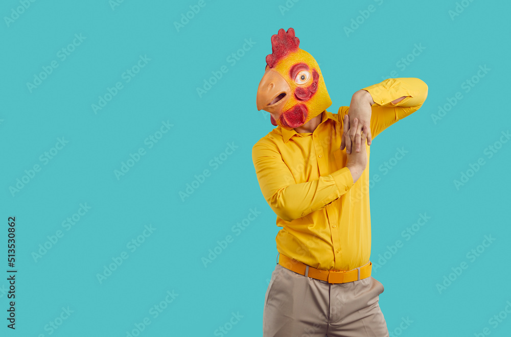 Cheerful funny man in rubber mask of chicken head has fun during ...