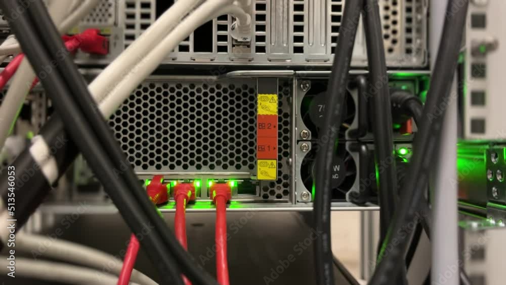 Rear view of a server in a server room with its network connections and ...