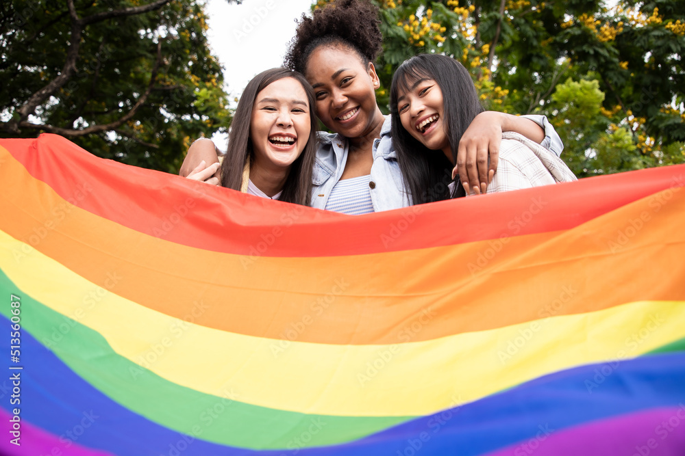 Foto de Diversity young gay women with Asian gay embrace pride rainbow ...