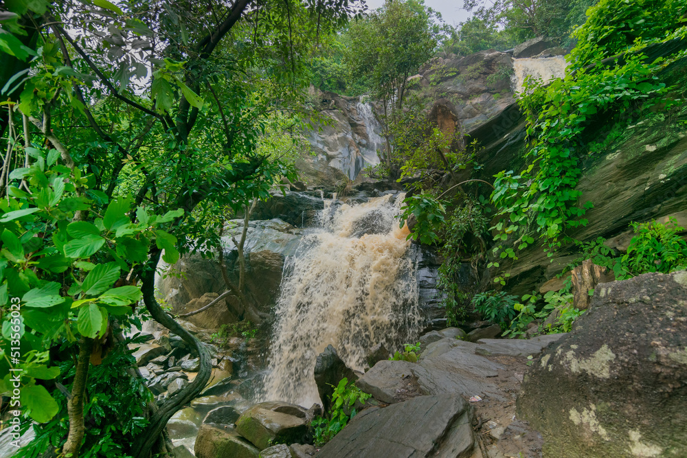 Beautiful Bamni waterfall having full streams of water flowing downhill ...