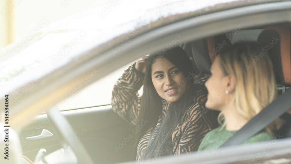 Two Young women smiling in a car enjoying a road tripping concept best ...