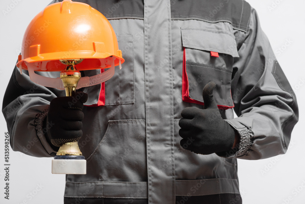 Builder contractor with the golden award trophy cup with the hardhat ...