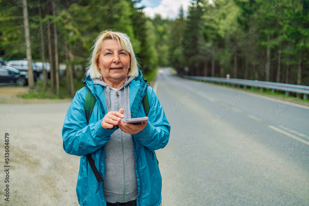 Female hand using smart phone with navigator location point at top of ...