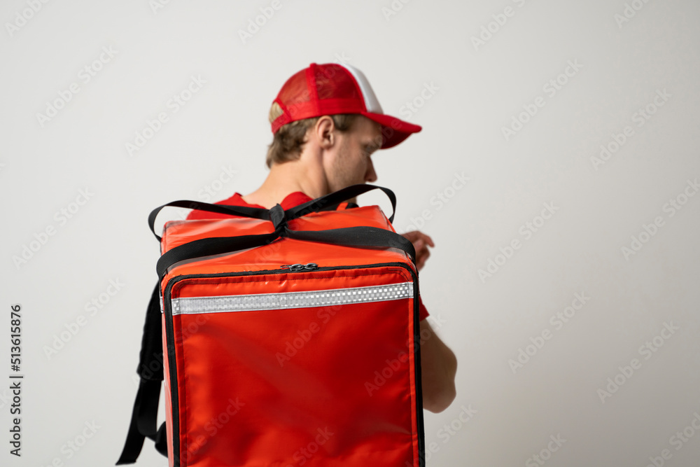 Foto de Delivery guy employee man in red cap T-shirt uniform work as ...